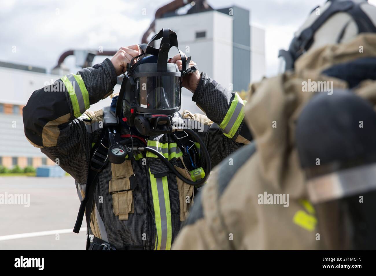 Firefighter putting on gas mask hi-res stock photography and images - Alamy