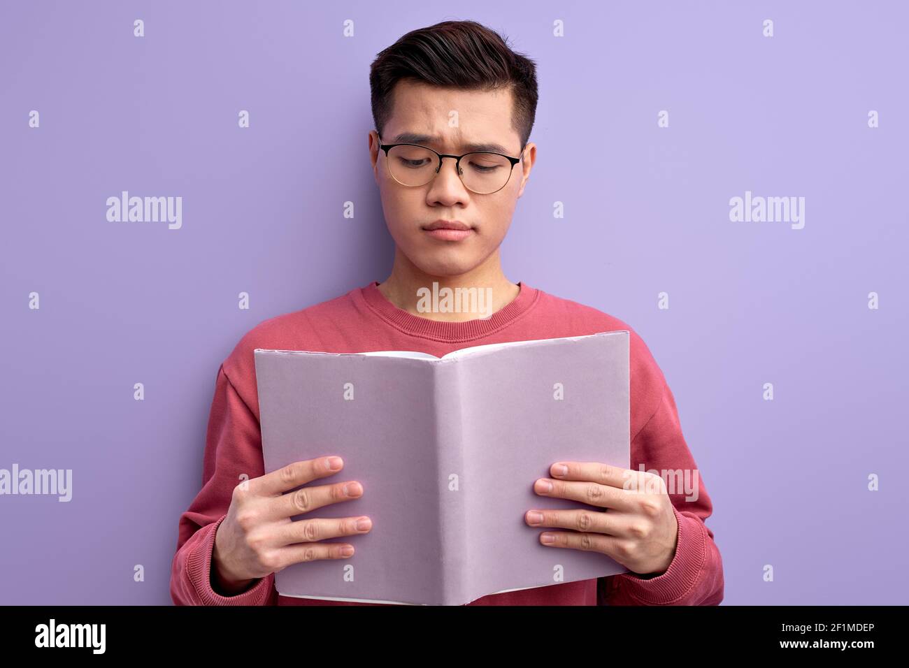 Handsome Chinese Man Reading Book Isolated In Studio , Asian Guy In ...
