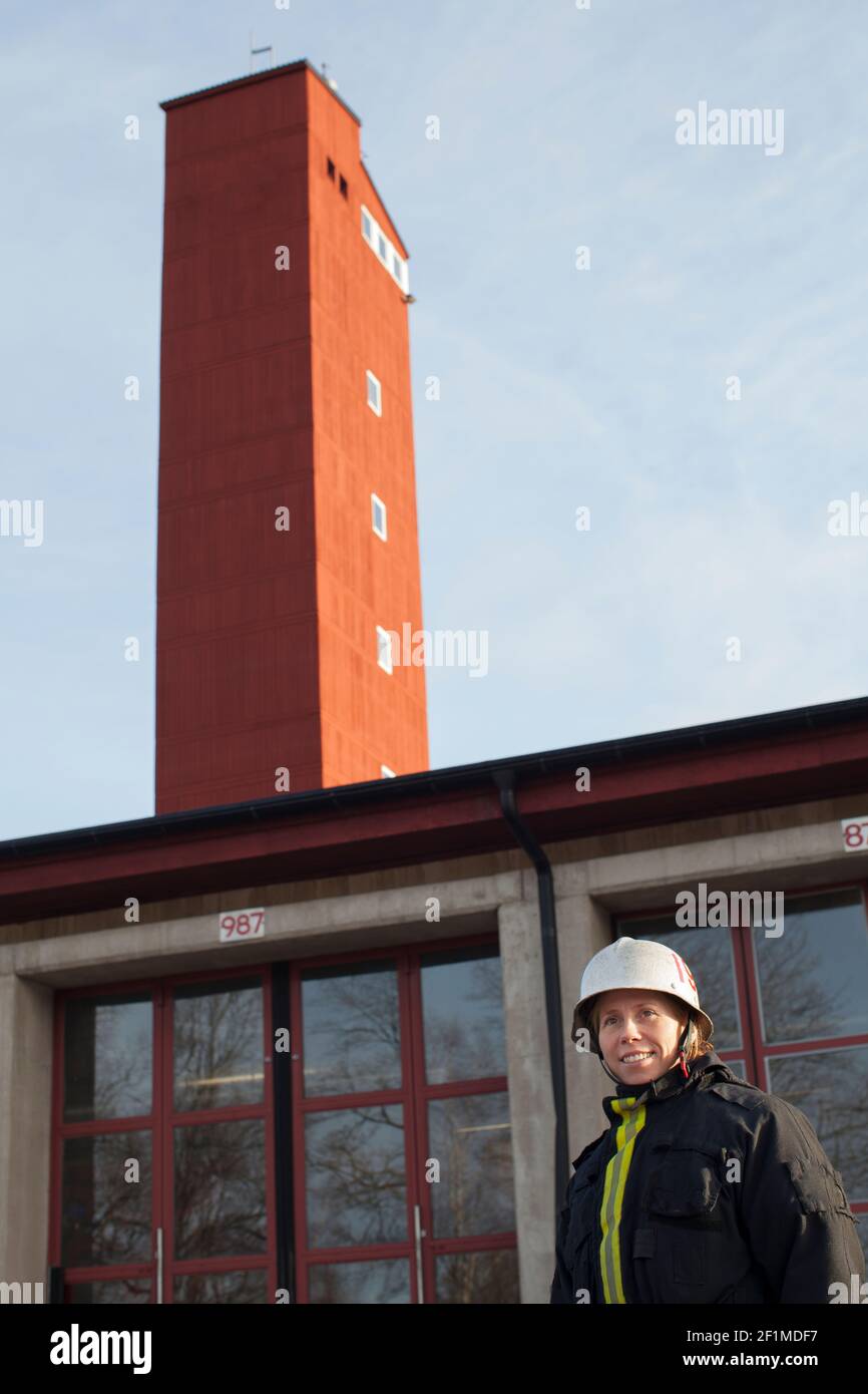 Female firefighter in front of fire station Stock Photo - Alamy