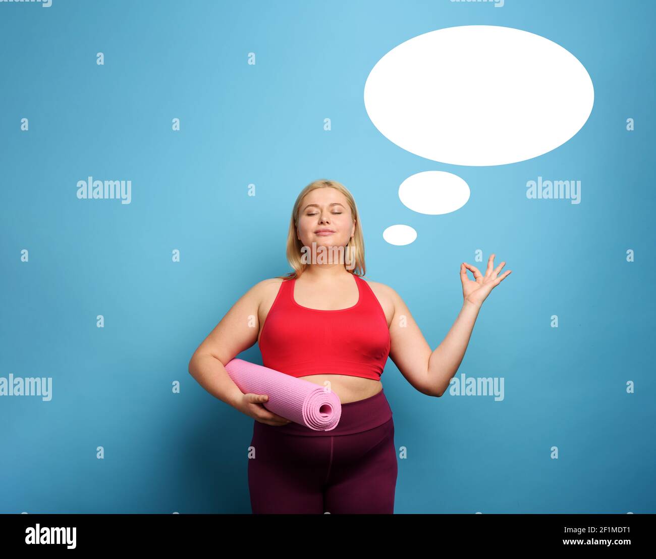 Fat girl does gym at home. thoughtful expression. Cyan background Stock ...