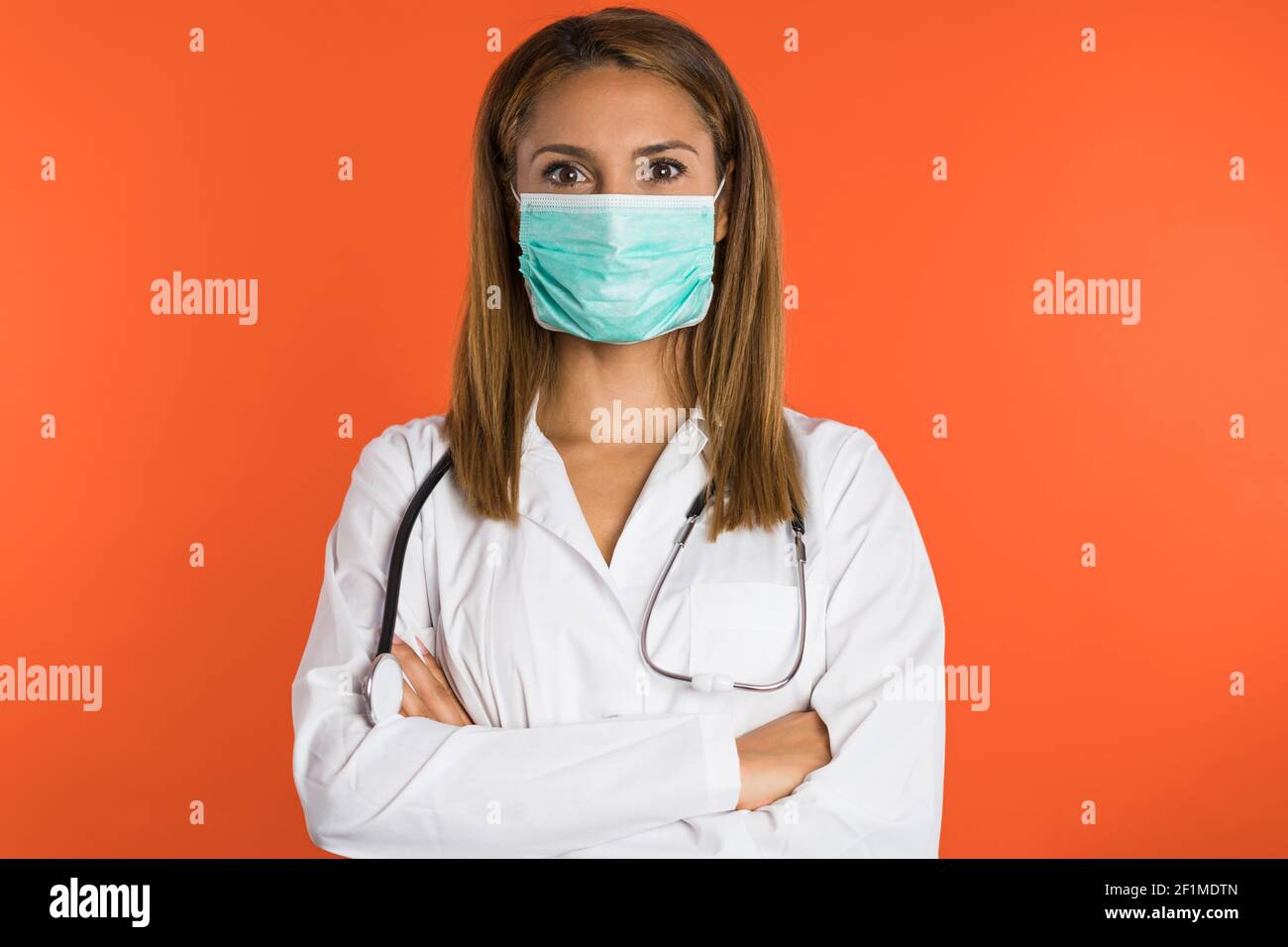 Women doctor with face mask smiles in front of the camera Stock Photo ...