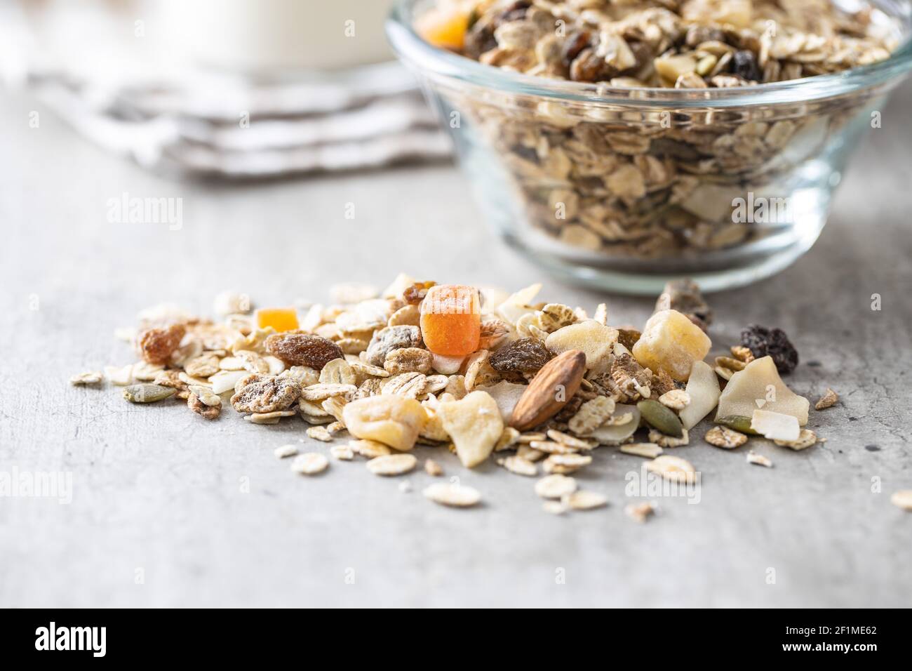 Beakfast cereals on kitchen table. Healthy muesli with oat flakes, nuts ...