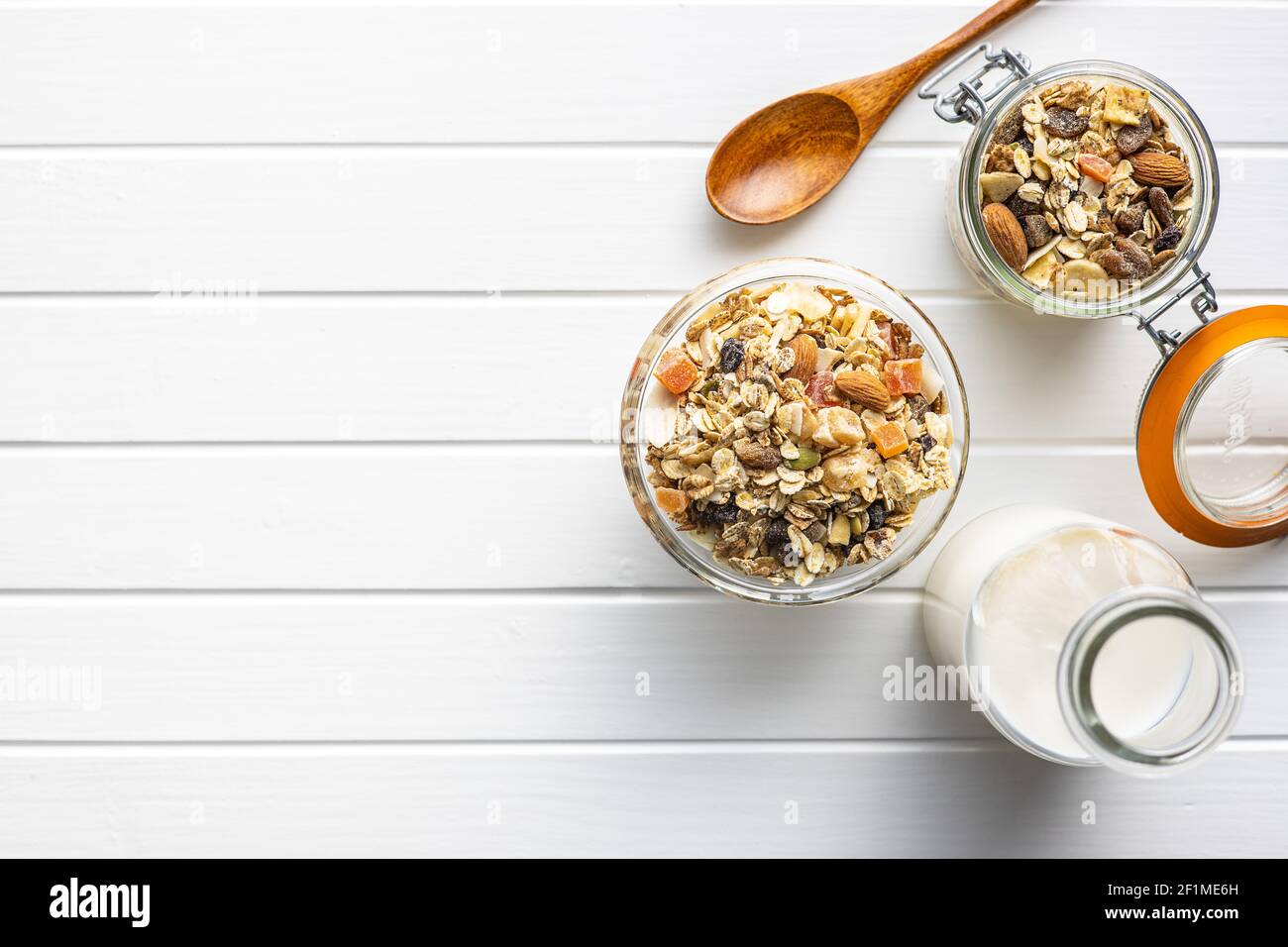 Beakfast cereals in bowl and milk in bottle. Healthy muesli with oat ...