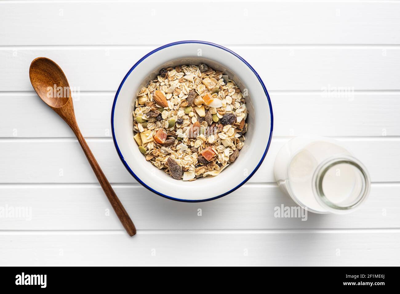 Beakfast cereals in bowl and milk in bottle. Healthy muesli with oat ...