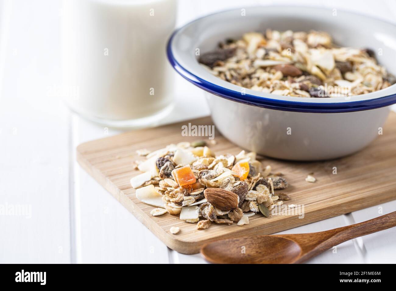 Beakfast cereals on cutting board. Healthy muesli with oat flakes, nuts ...