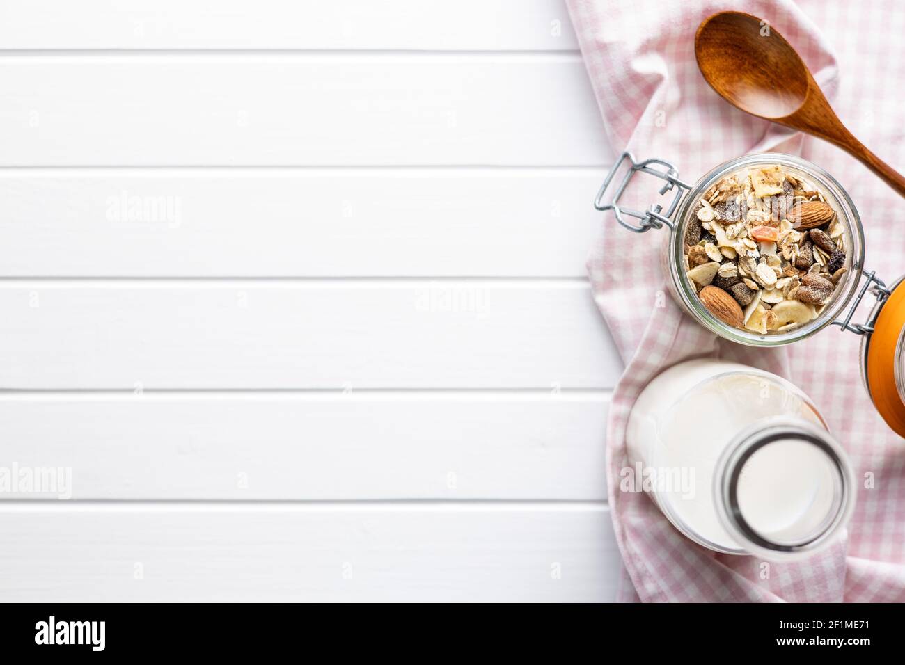 Beakfast cereals in bowl and milk in bottle. Healthy muesli with oat ...