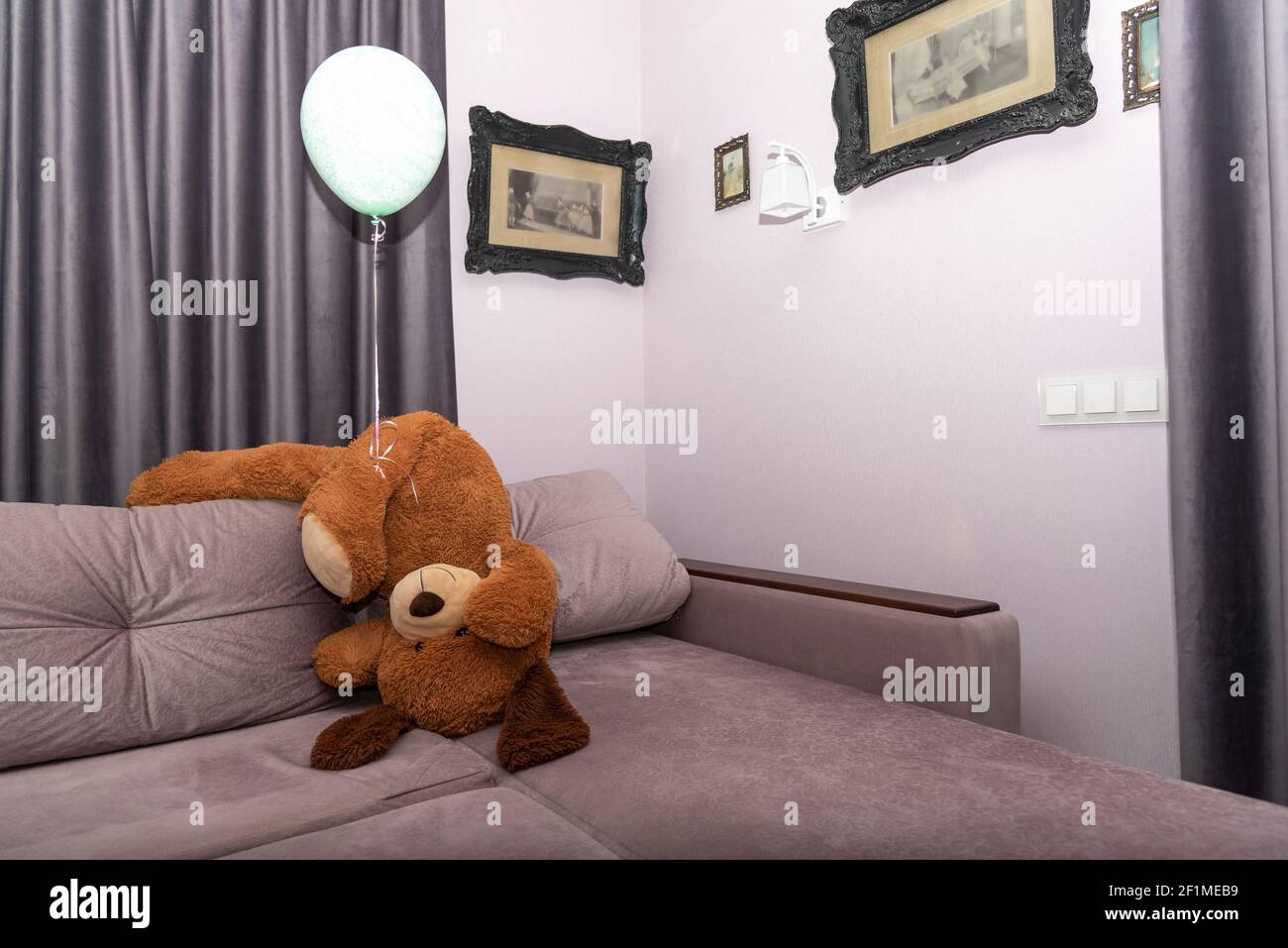 Handstanding stuffed toy with balloon. Funny Teddy bear turned upside ...