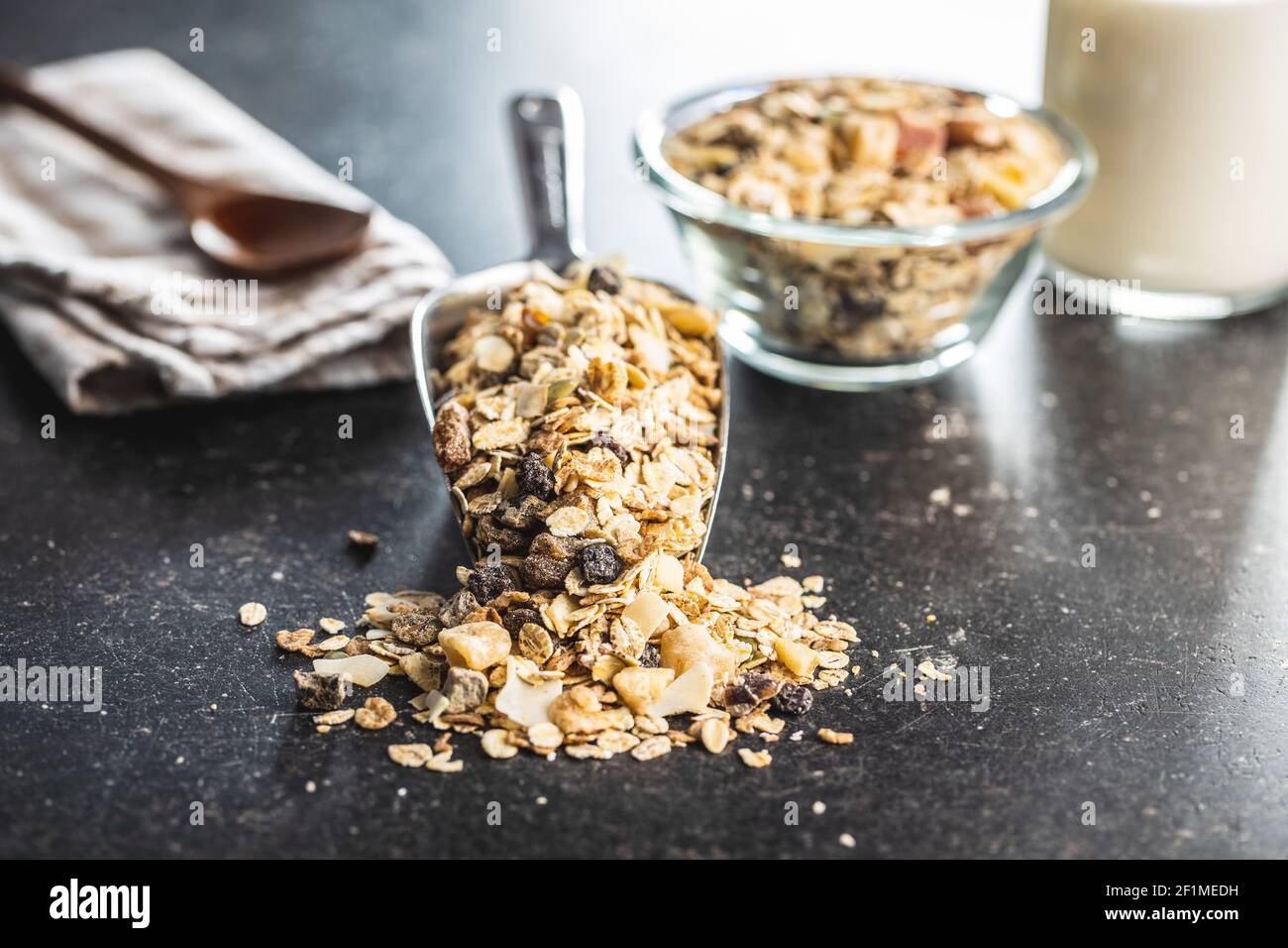 Beakfast cereals in scoop. Healthy muesli with oat flakes, nuts and ...