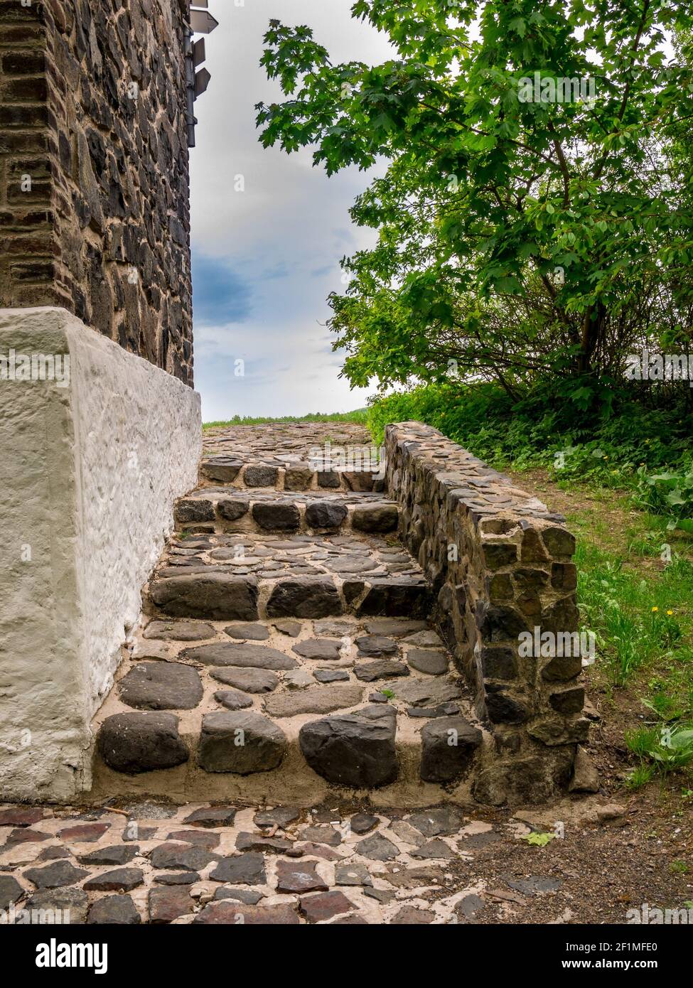 Stone stairs with a small stone wall at the side of the building Stock ...