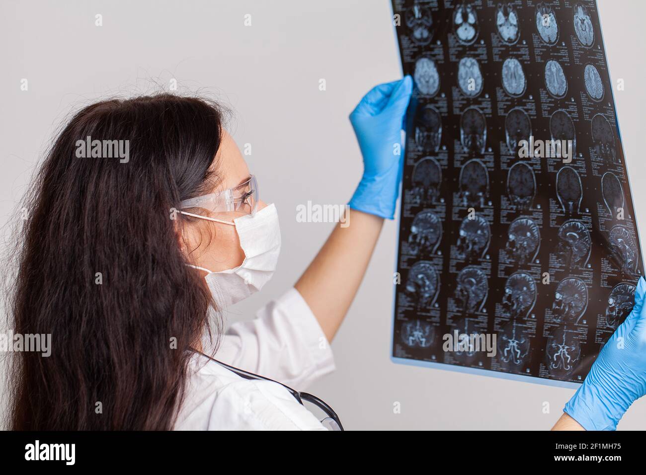 Beautiful female radiologist looking at the MRI scan images Stock Photo ...