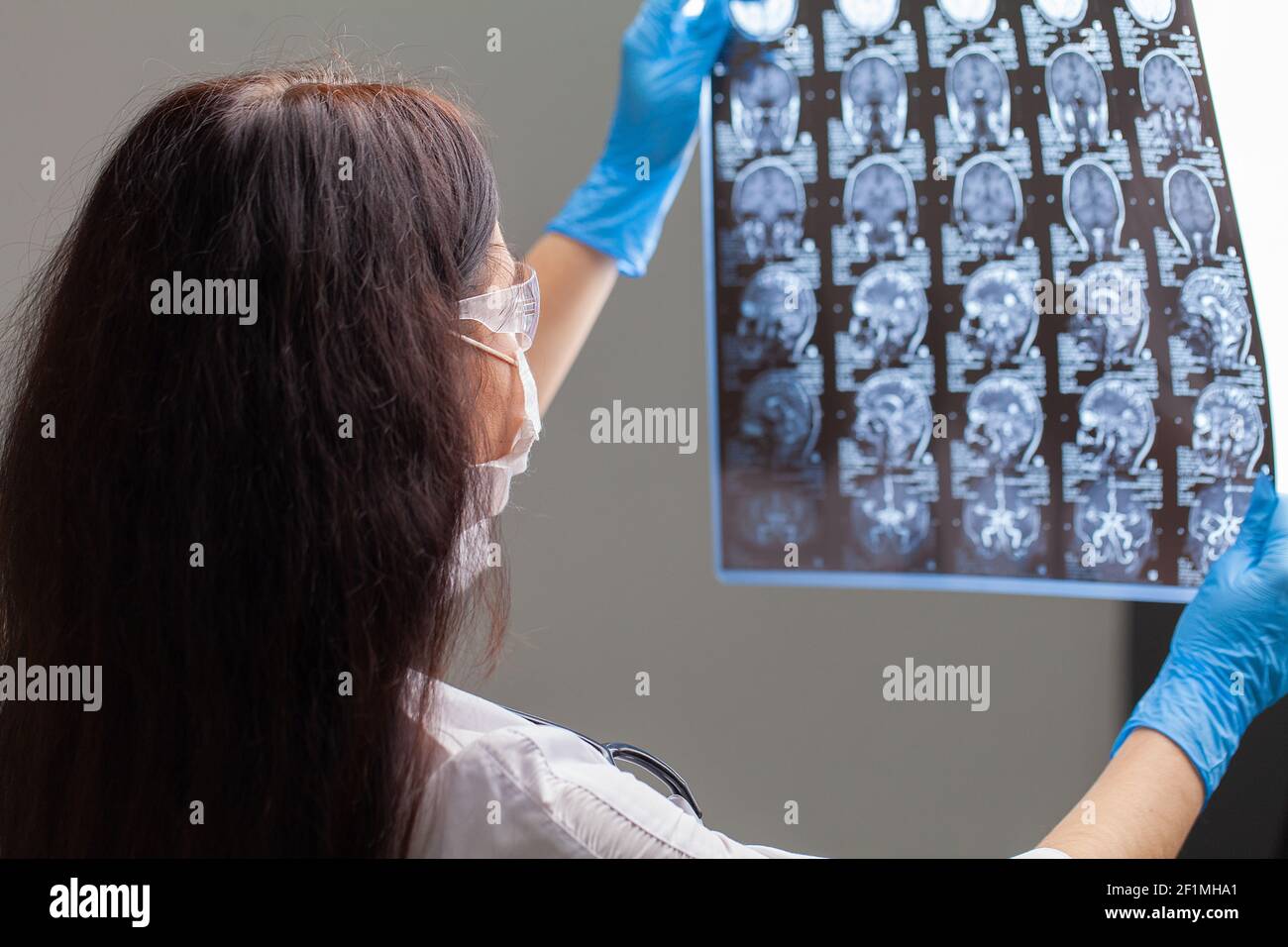 Beautiful female radiologist looking at the MRI scan images Stock Photo ...