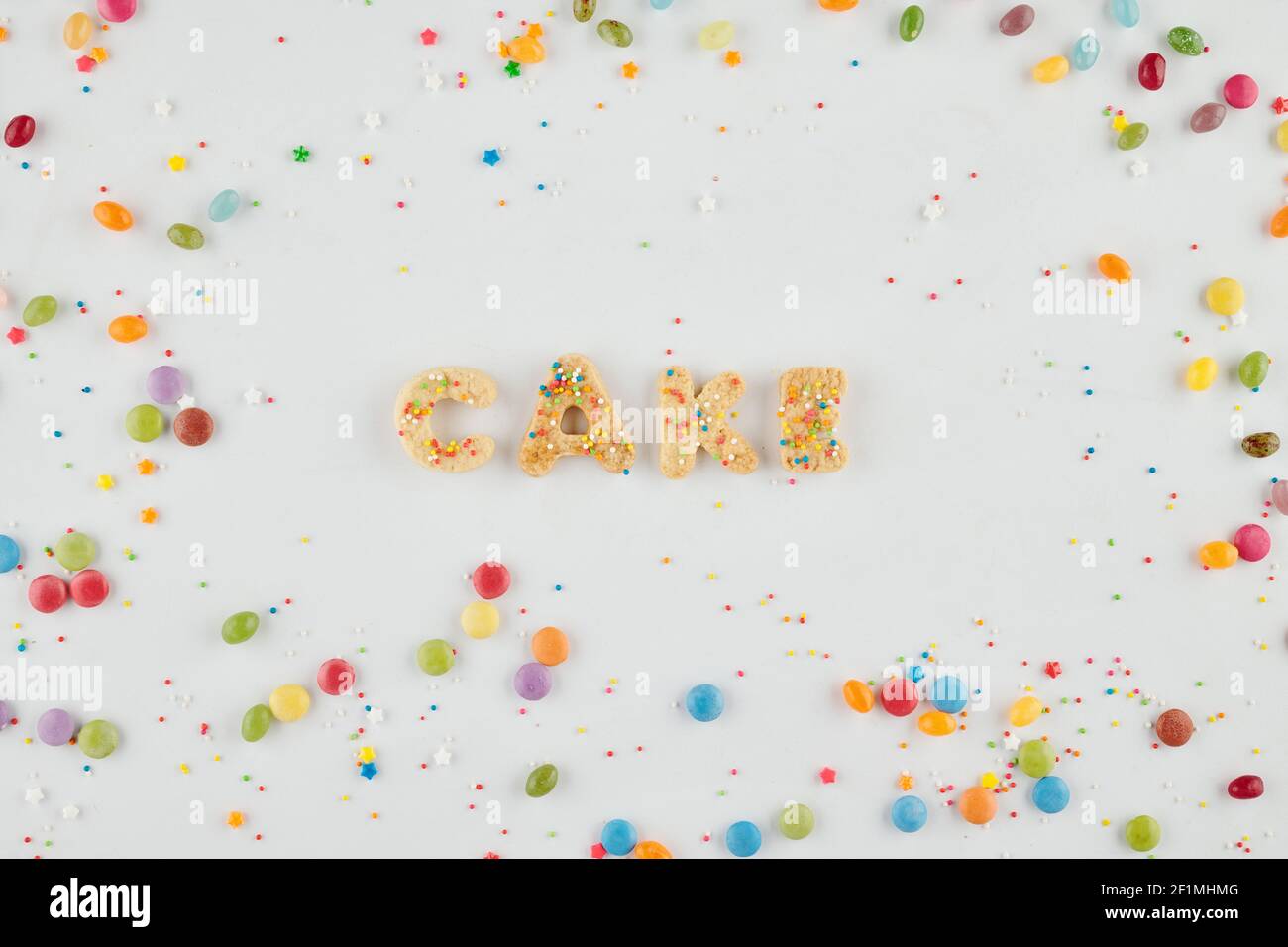 Word cake made of sugar cookies, colorful candies and sprinkles around ...