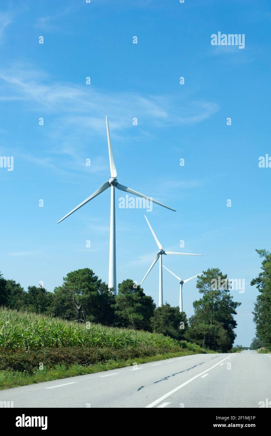 Wind turbines line the side of a country road Stock Photo - Alamy