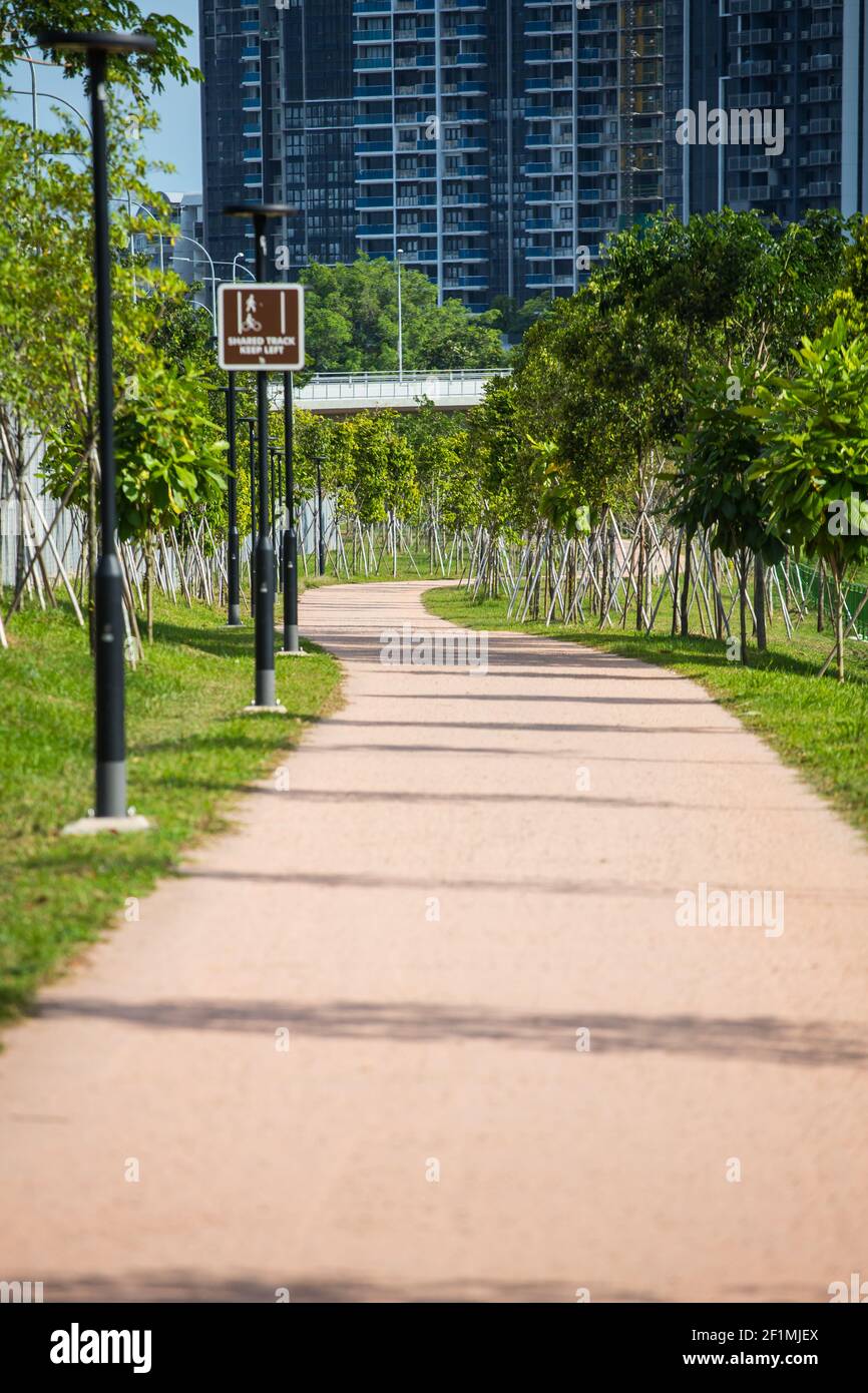 Long stretch of greenery path for the public Stock Photo - Alamy