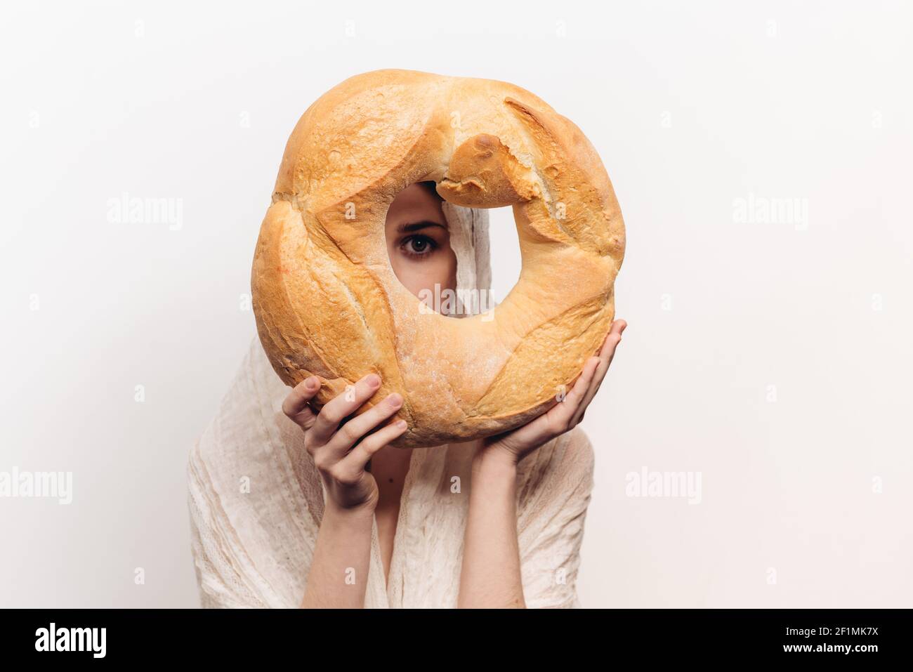 woman with round loaf of bread loaf model with transparent cloth on her ...