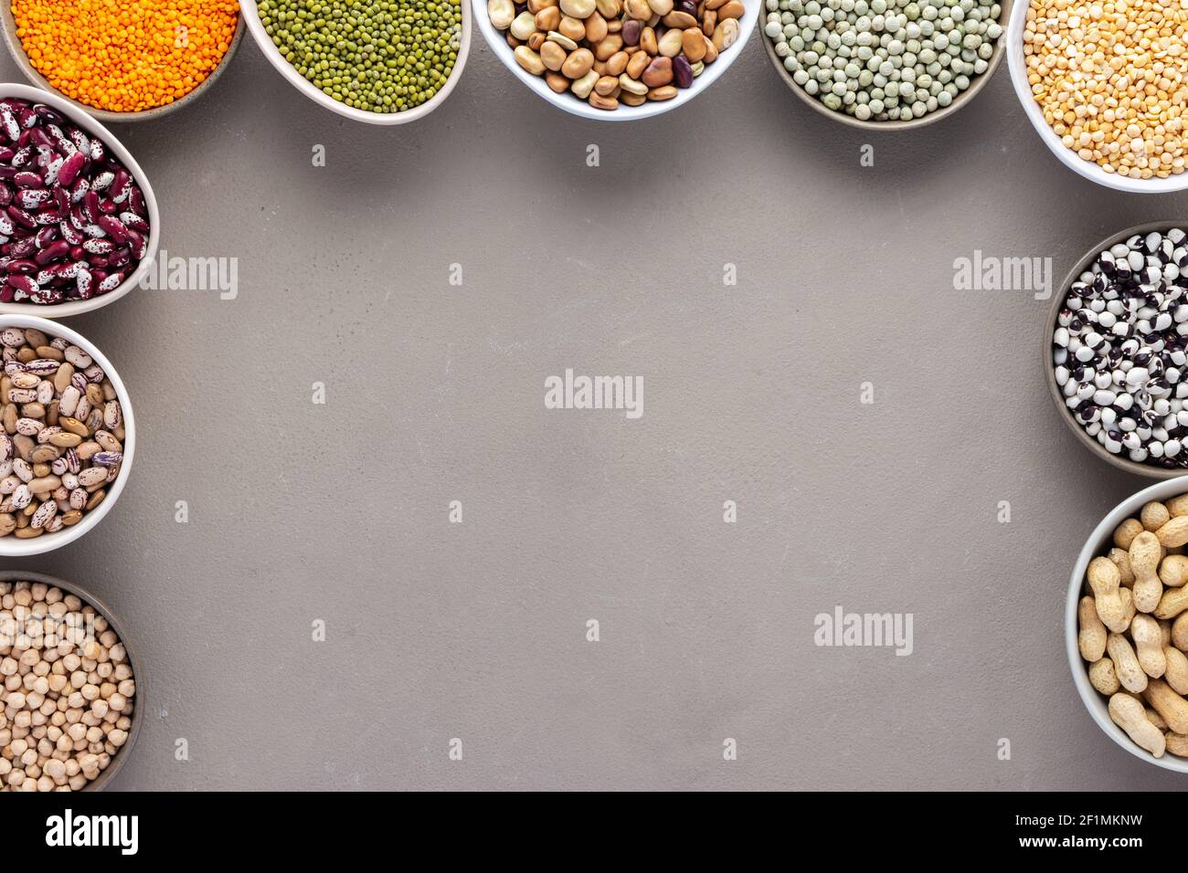 Different types of legumes in bowls, green and yellow peas, chickpeas ...