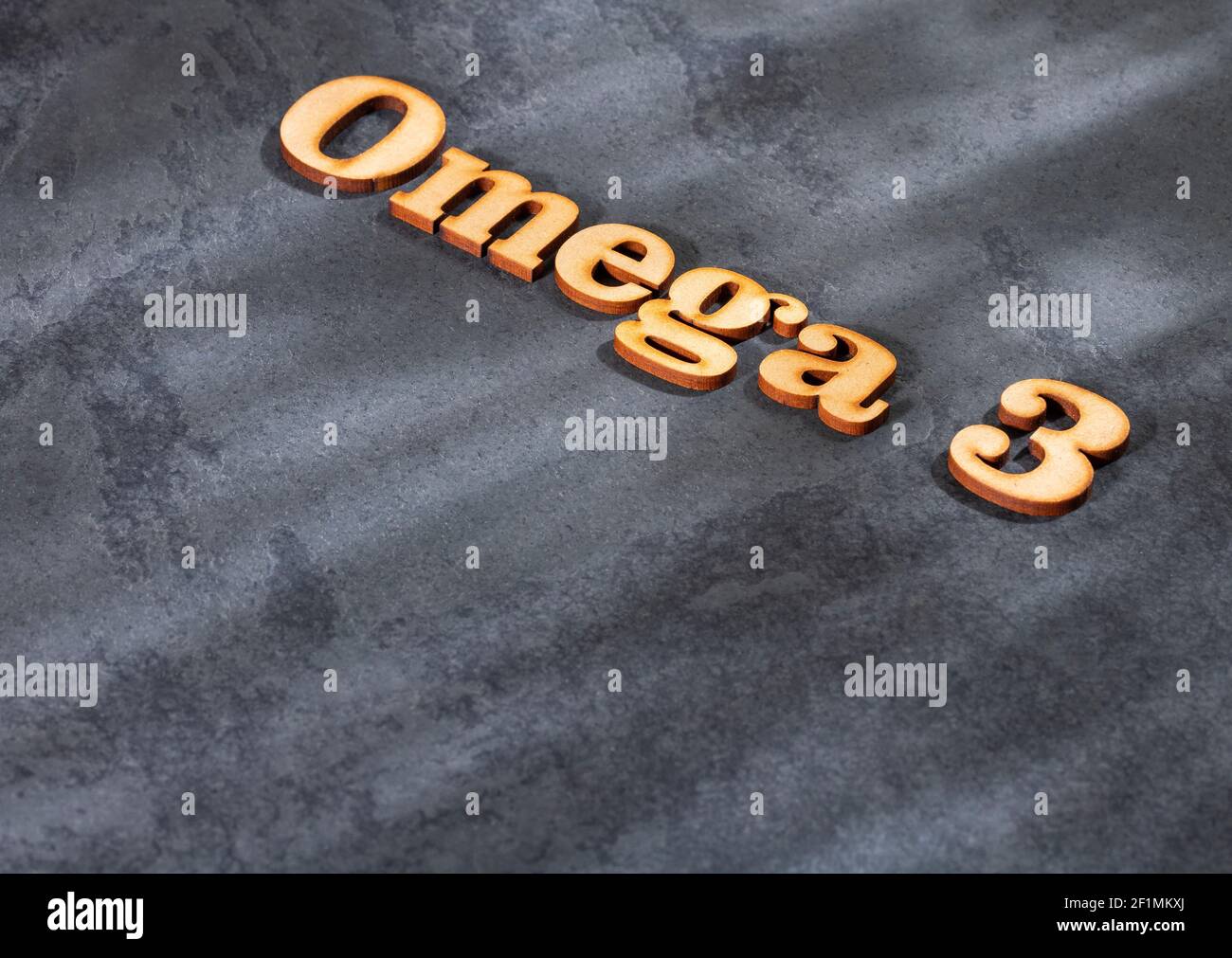 Word omega 3 in wooden letters - text space Stock Photo - Alamy