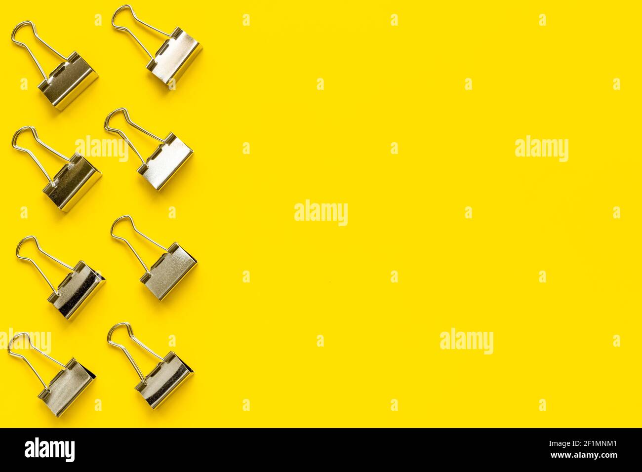 Frame of silver paper binder clips top view. Office supplies pattern ...