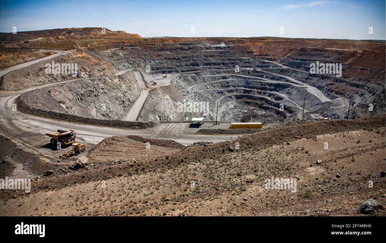 Copper ore open-pit mining. Quarry dump truck and excavator on road ...