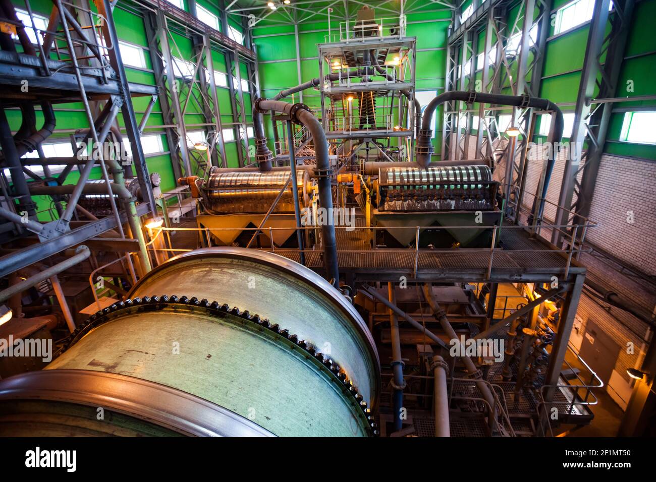 Gold ore refining plant. Ball mill on foreground. Gold gravity spiral ...