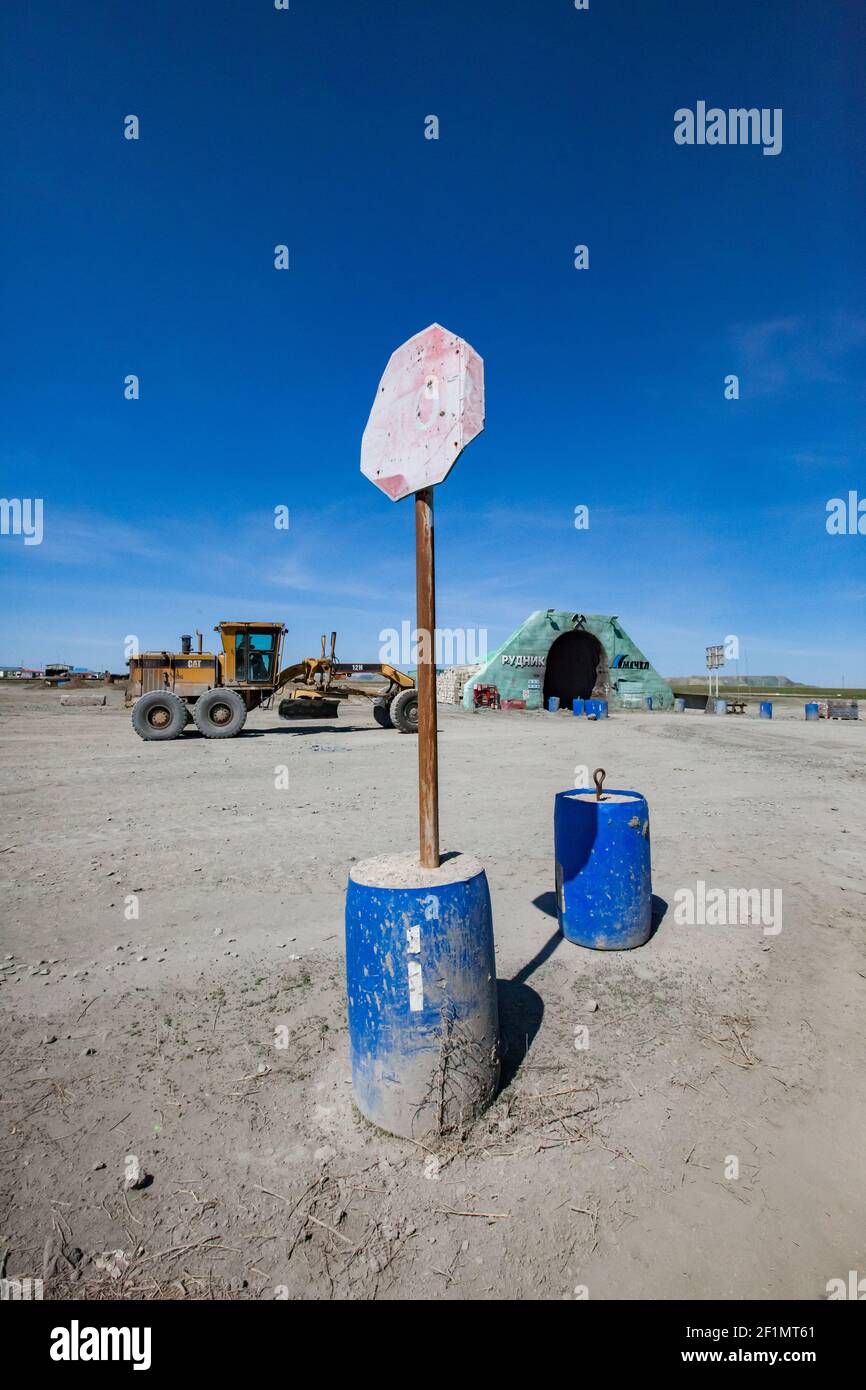 Hand-made and fade road sign STOP on plastic barrel with concrete. Gold ...
