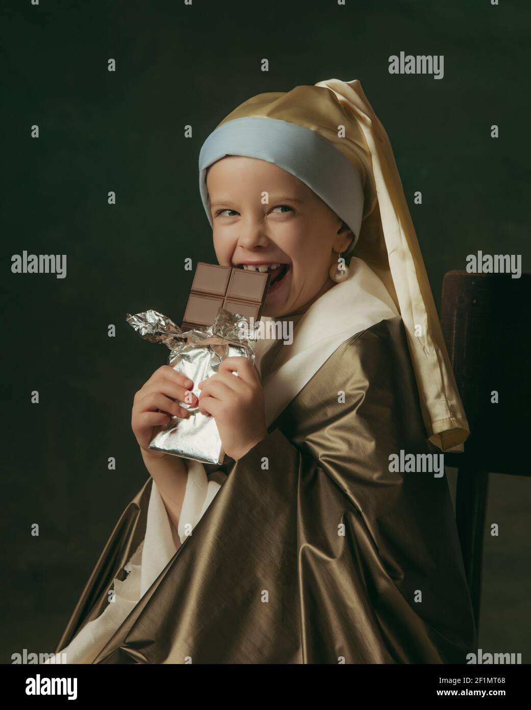 Chocolate lover. Medieval little girl as lady with a pearl earring on ...