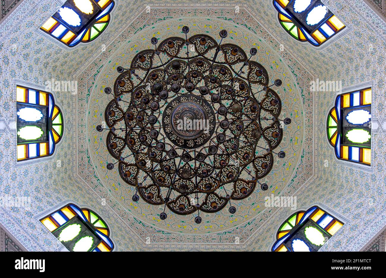 Bottom view of ceiling with stained glass windows and many ornaments ...