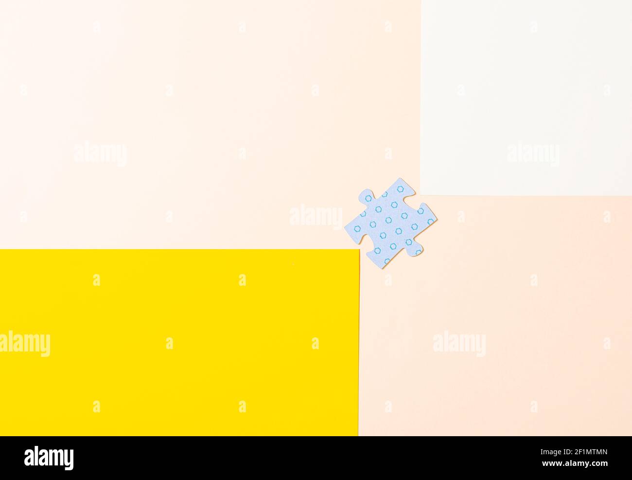Puzzle piece between two yellow and cream colored cardboard.The ...