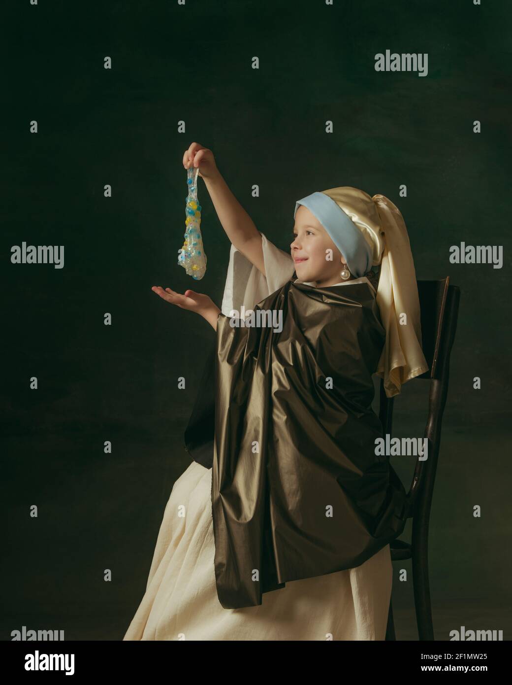 Slime. Medieval little girl as lady with a pearl earring on dark studio ...