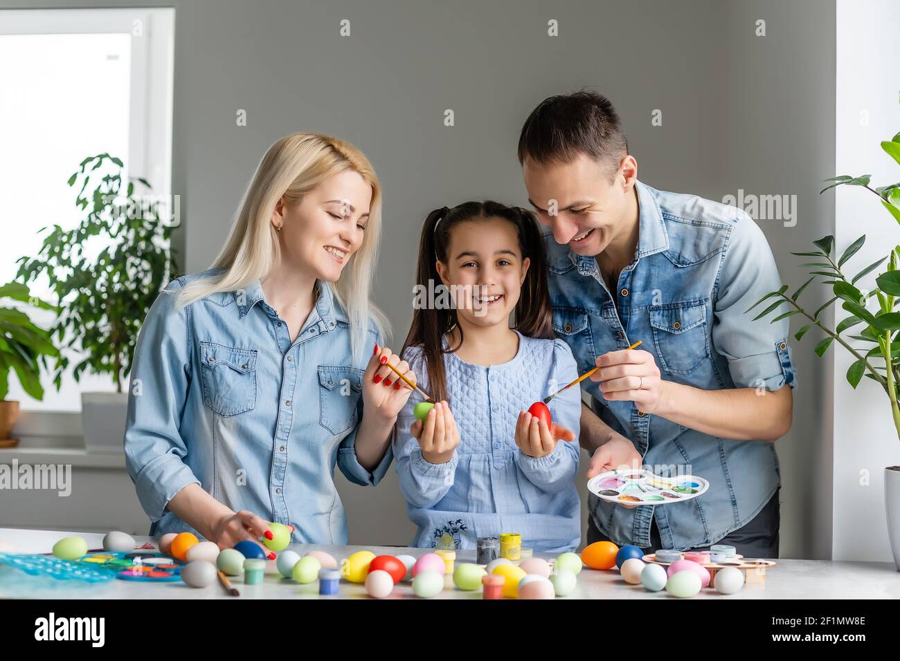 happy family with easter eggs. Happy family preparing for Easter Stock ...