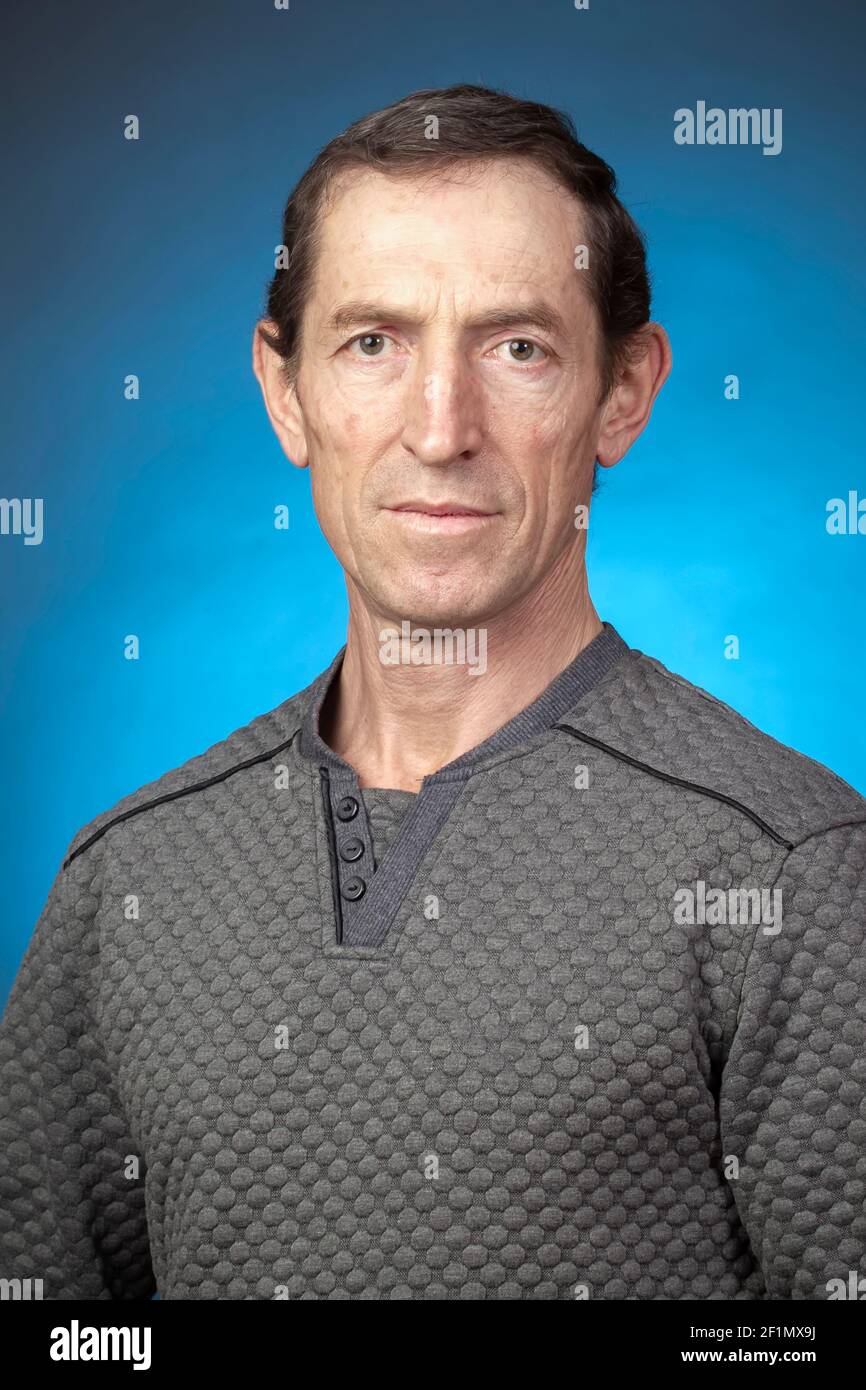 Portrait of an ordinary elderly man on a blue background Stock Photo ...