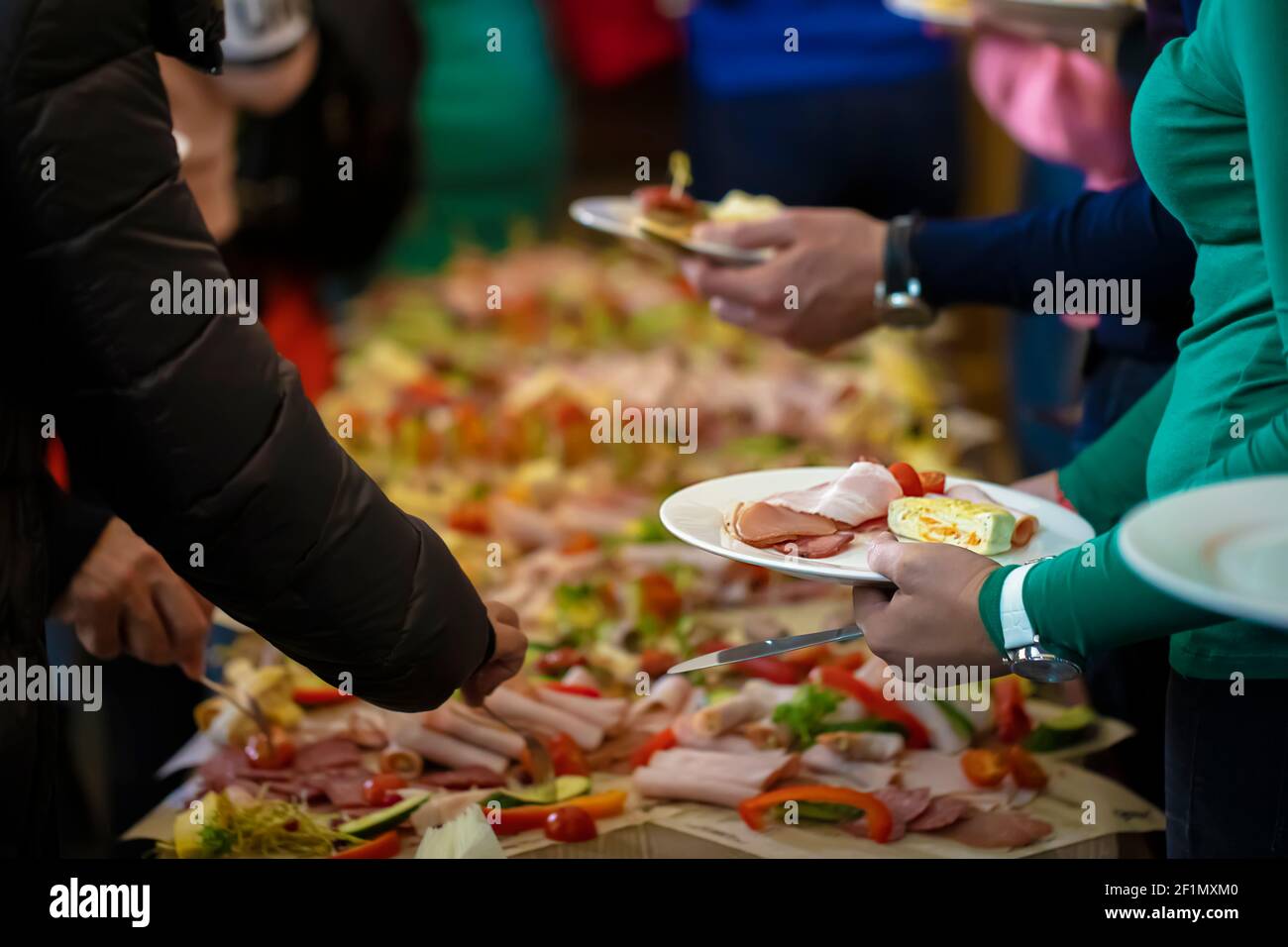 Buffet. Hands with a plate on the background of a table with food Stock ...