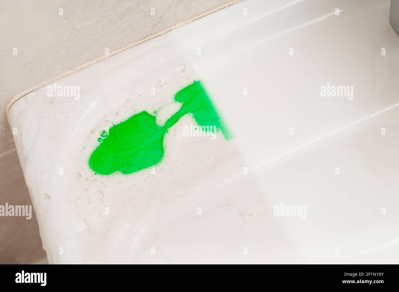 Photo of a white ceramic washbasin with detergent applied and after ...