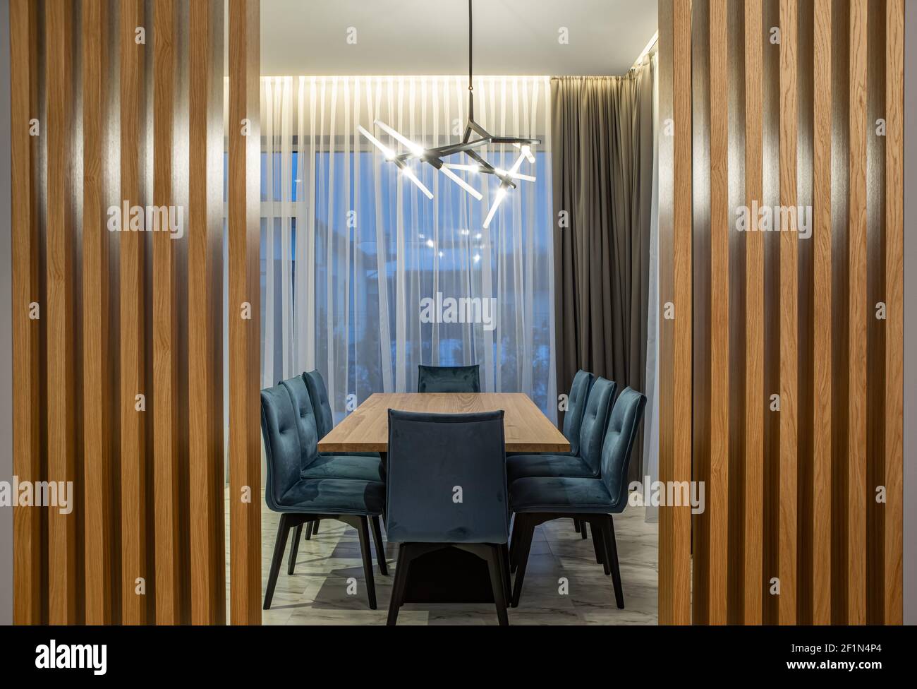 Modern interior of kitchen in luxury private house. Huge wooden table ...