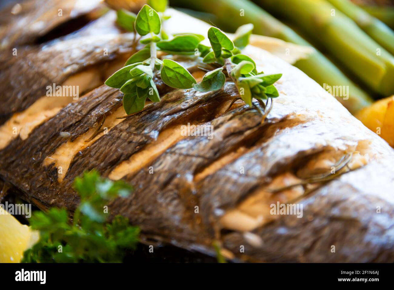 Roasted dorado fish with herbs and vegetables Stock Photo - Alamy