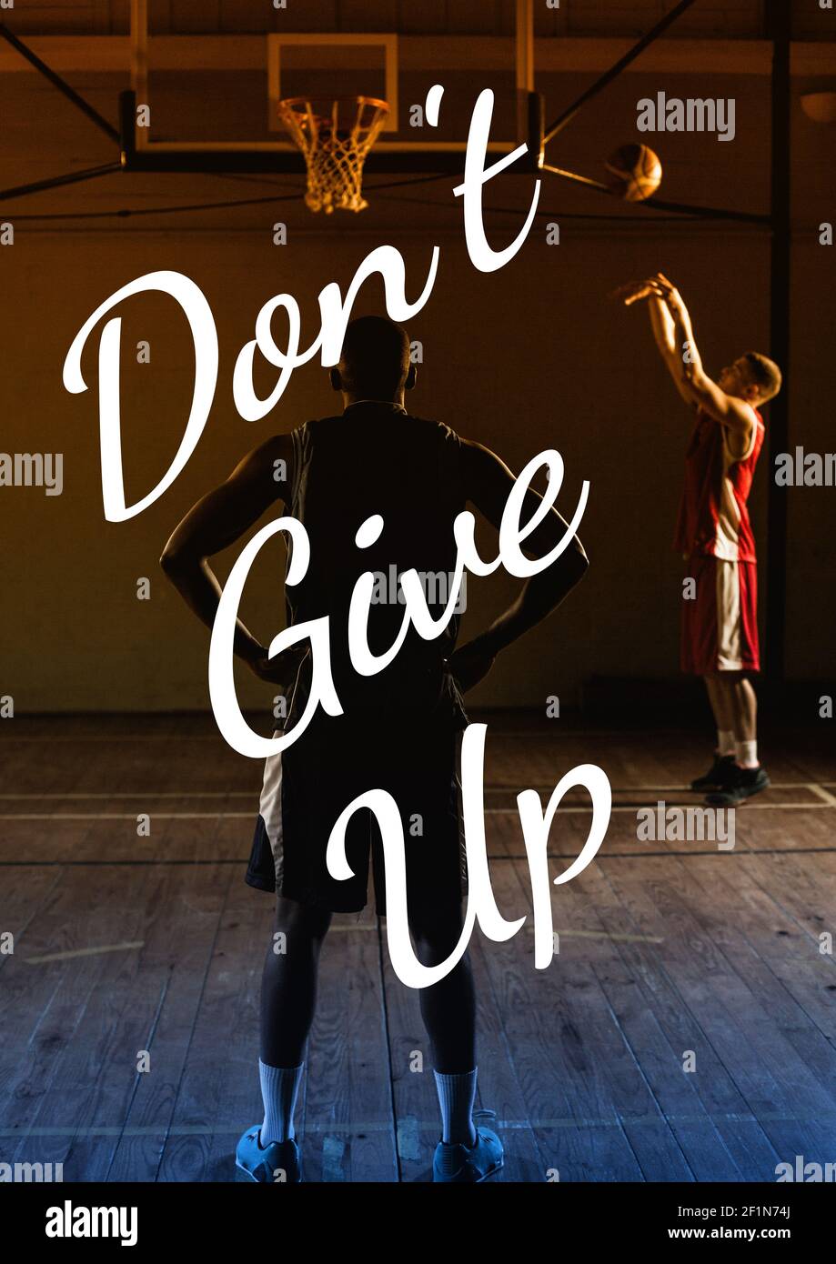 Don't give up text over two men playing basketball Stock Photo - Alamy