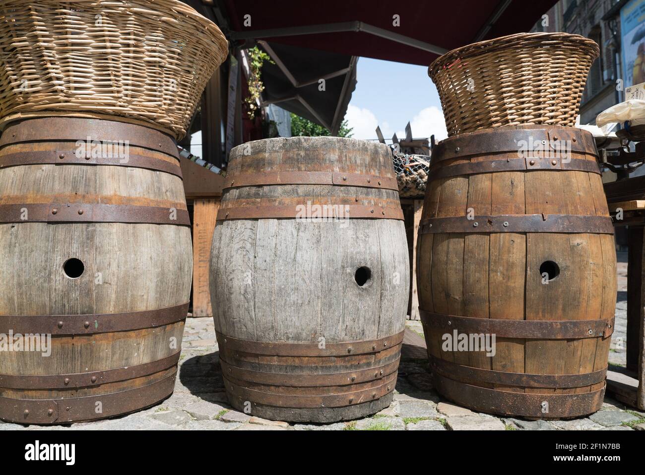 Old empty wooden cider casks used as bar tables and decorative articles ...