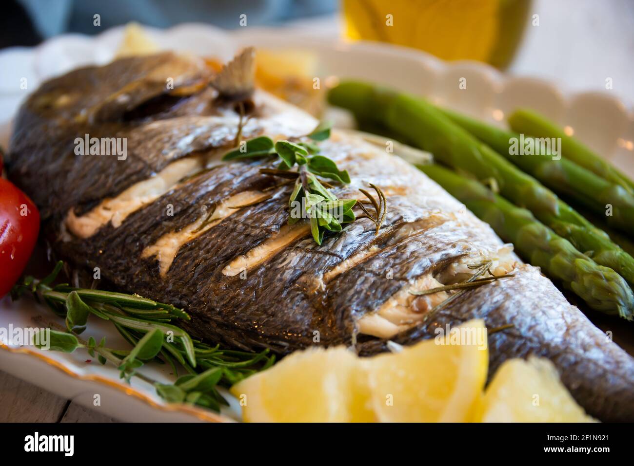 Roasted dorado fish with herbs and vegetables Stock Photo - Alamy