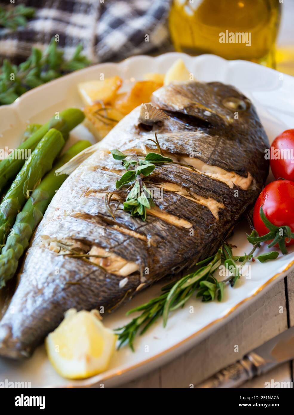 Roasted dorado fish with herbs and vegetables Stock Photo - Alamy