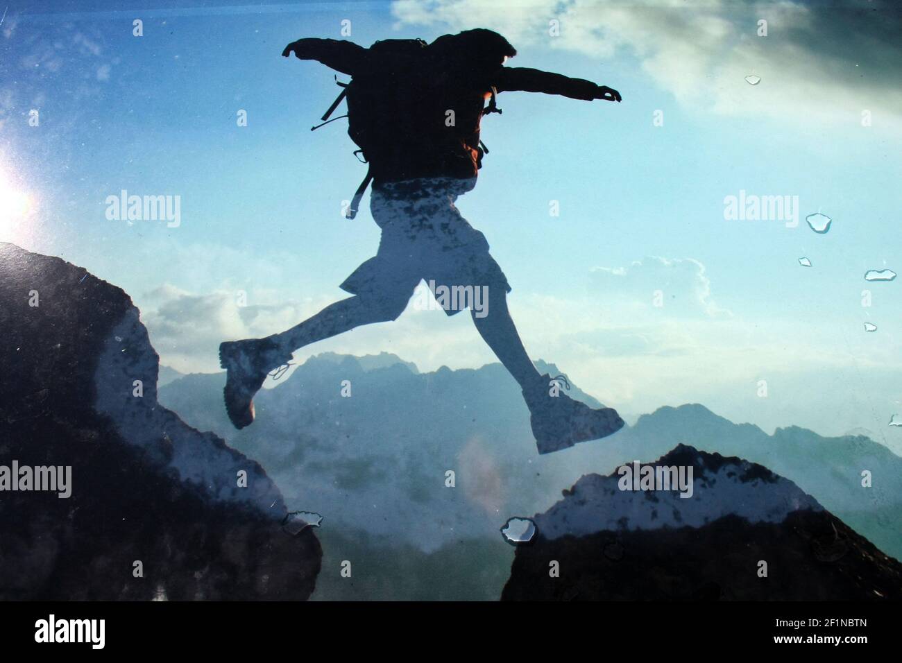 jumping over mountains, illustration shows man in the alps jumping over ...