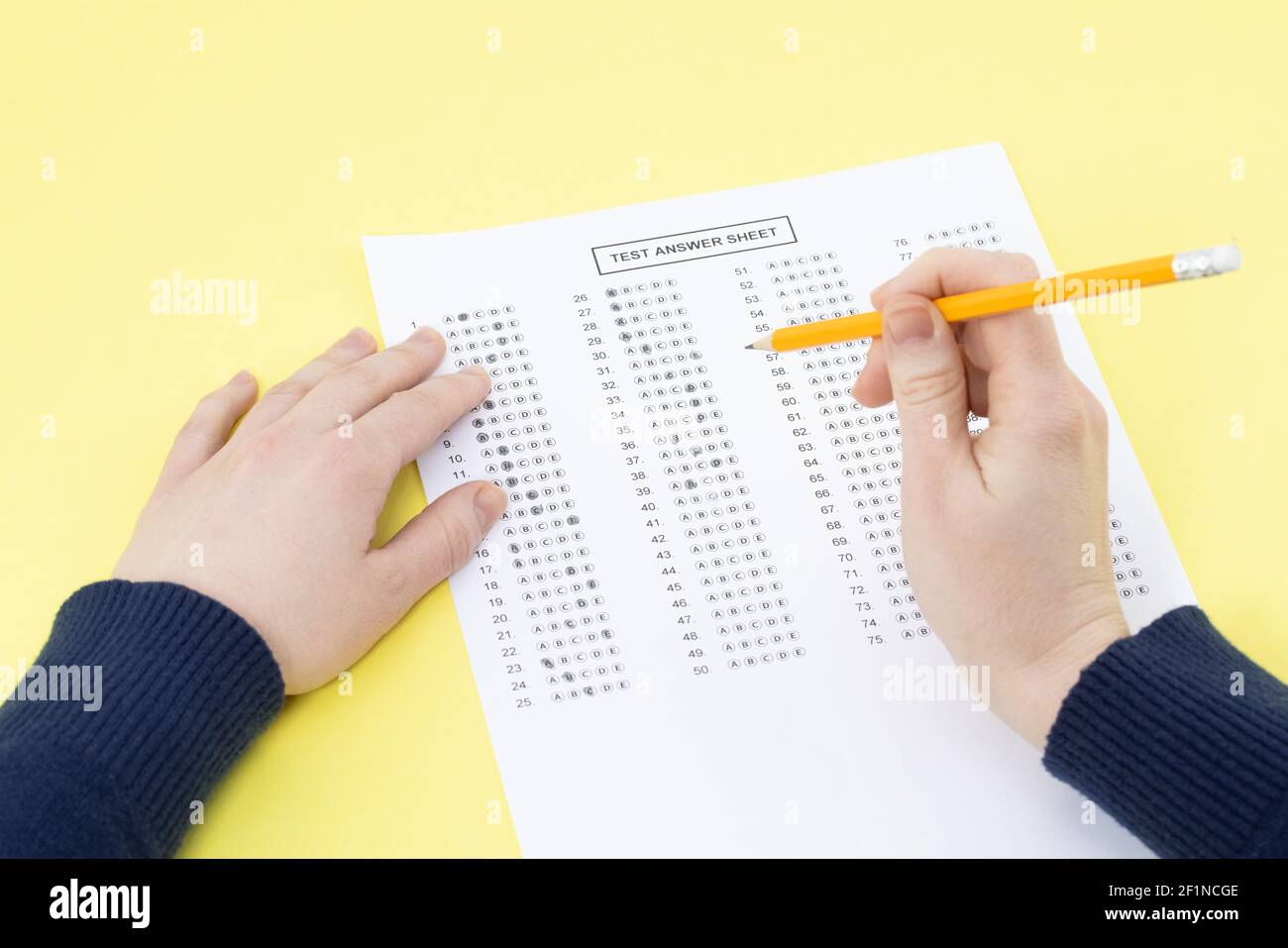 Exam. Filling in the test with a pencil Stock Photo - Alamy