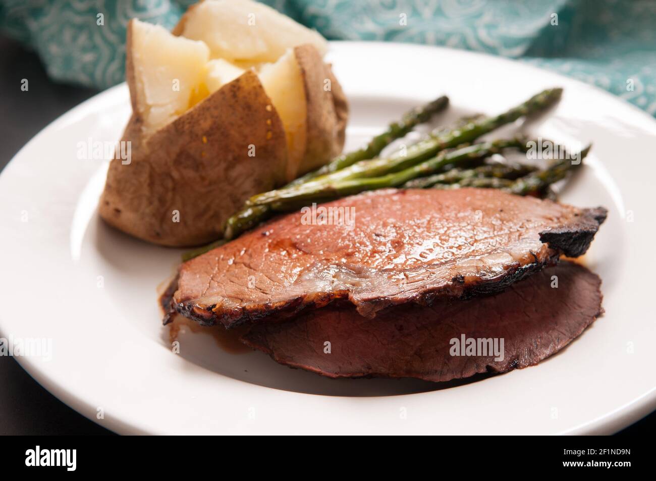 organic prime rib roast dinner with baked potato and asparagus Stock ...