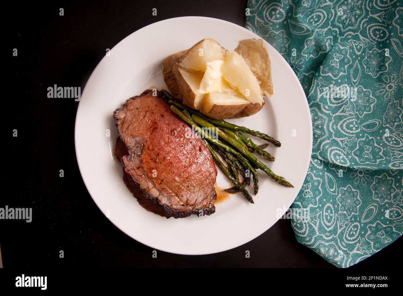organic prime rib roast dinner with baked potato and asparagus Stock ...