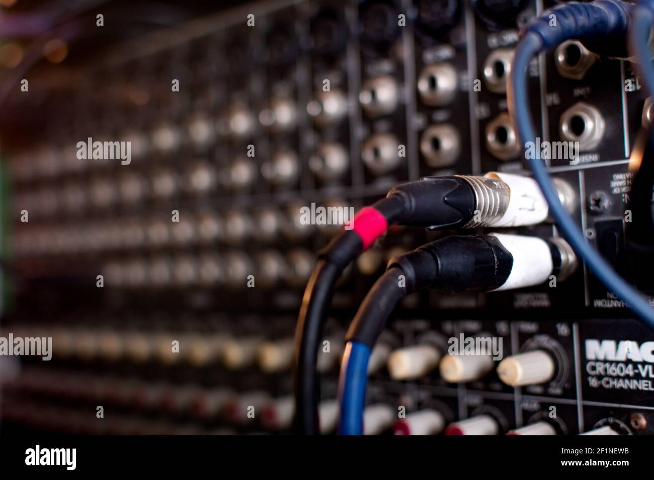 Closeup of colorful cables connected to a guitar amplifier inside a ...