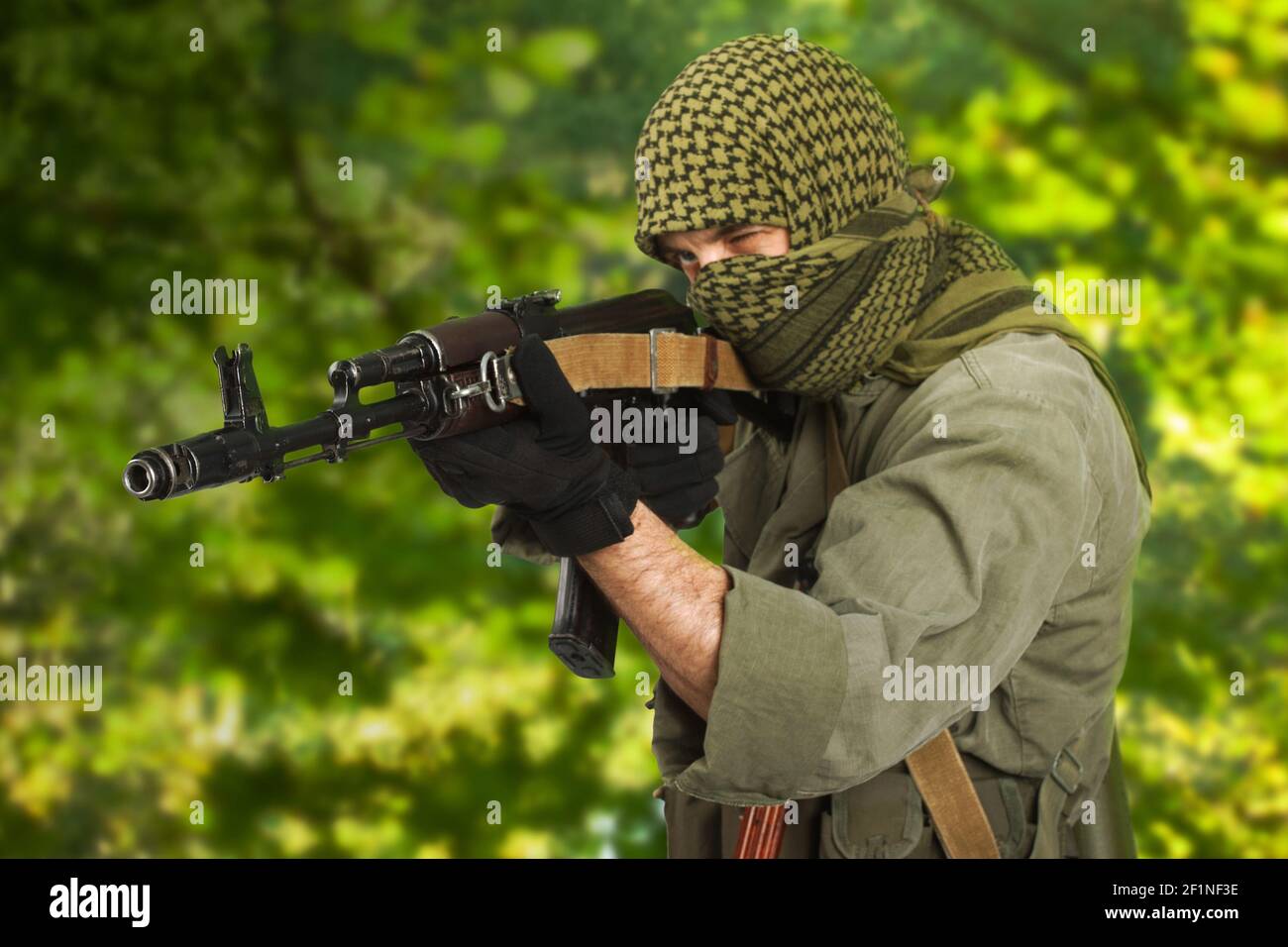 guerilla fighter firing AK 47 gun in jungle forest Stock Photo - Alamy