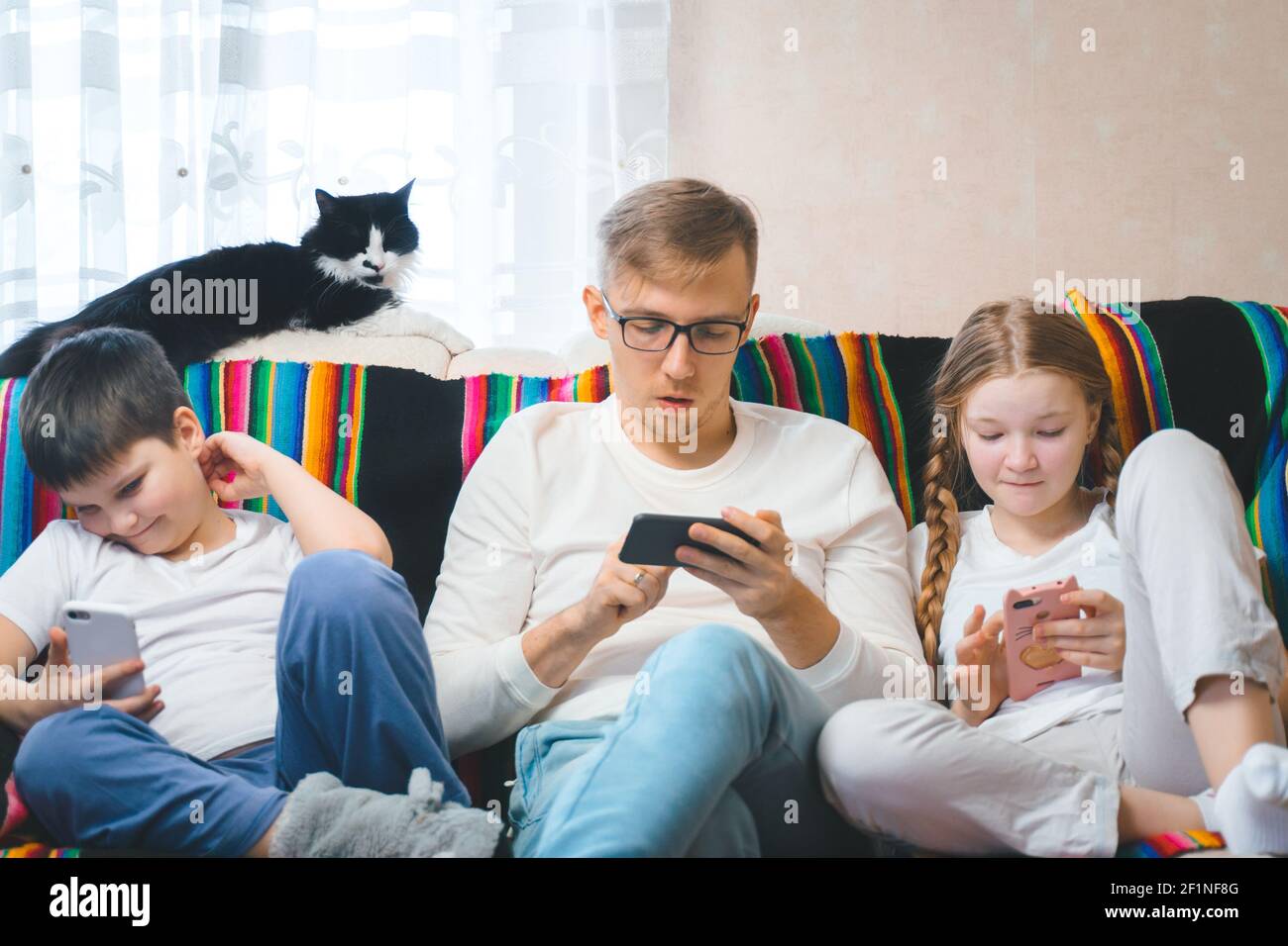 Happy alone dad looking at phone screen with children kids. smiling ...