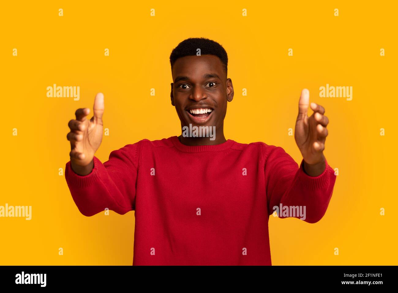 Come To Me. Excited Black Guy Extending Hands At Camera, Holding Big ...