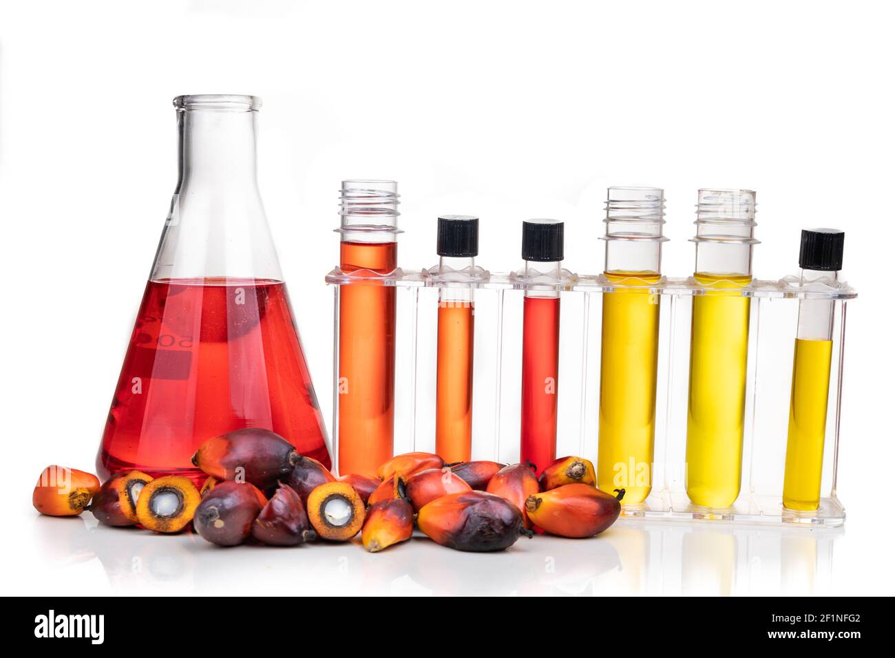 Red color unrefined palm oil and fruits with beaker test tube in ...