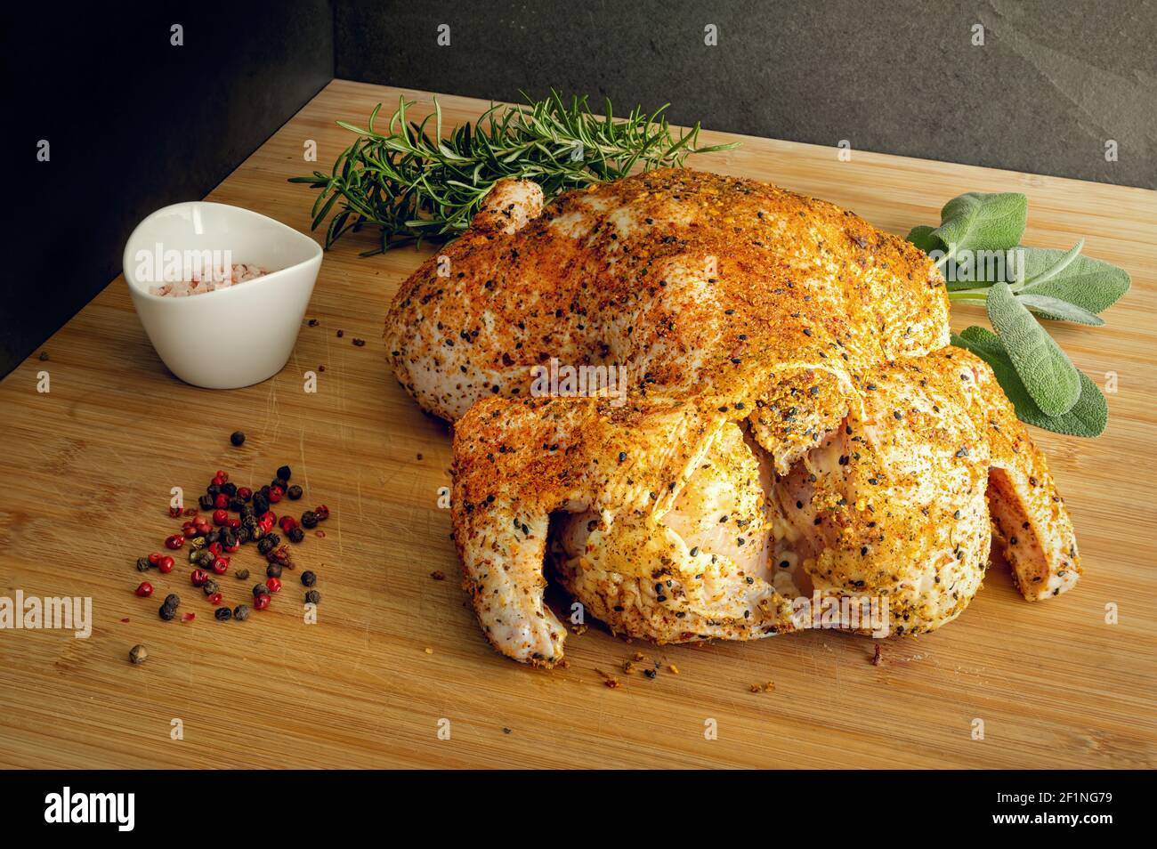 Whole raw chicken rubbed with spices, ready for bbq Stock Photo - Alamy