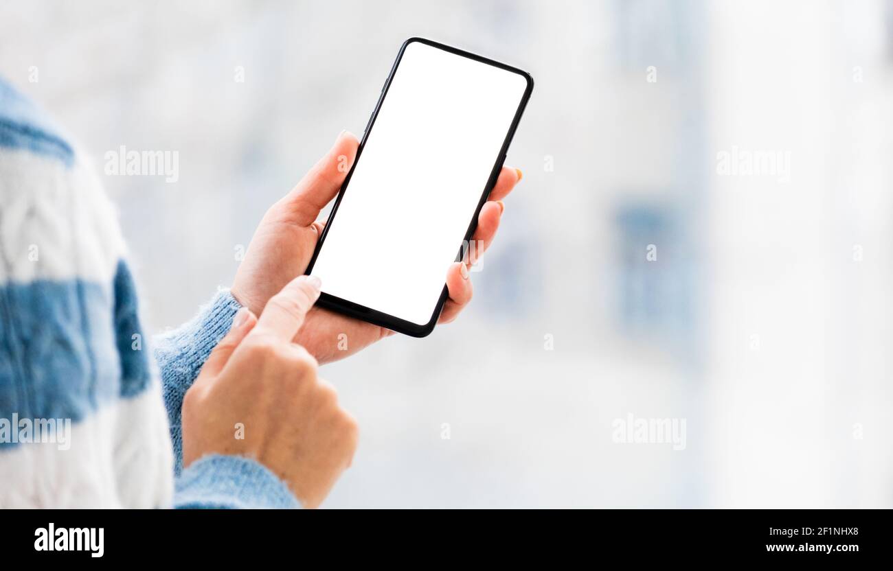 Hand holding mobile phone with white screen Stock Photo - Alamy